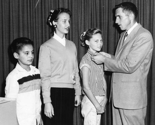 Youths receive Tri-C pins — Calisphere