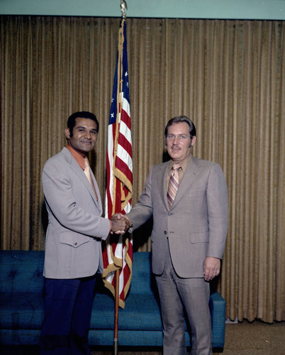 Billy Mills with unidentified man at Los Angeles City Hall — Calisphere