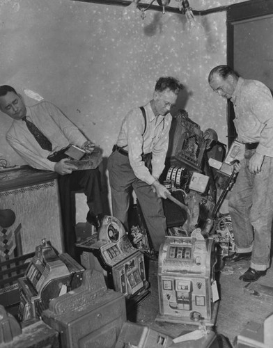 Officers destroy slot machines — Calisphere