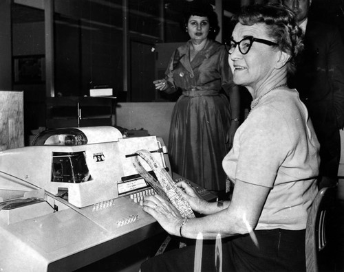 Police Administration Building clerk with new teletype machine — Calisphere