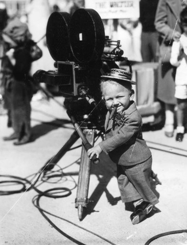 Child behind movie camera — Calisphere