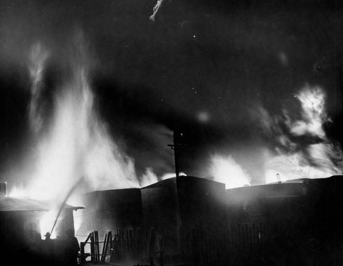 Firemen fight an oil fire — Calisphere