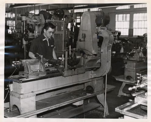 [Student working at a lathe in the machine shop at Polytechnic High ...