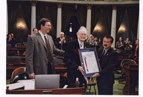 George Nakano giving Ralph C. Dills an Assembly Resolution — Calisphere