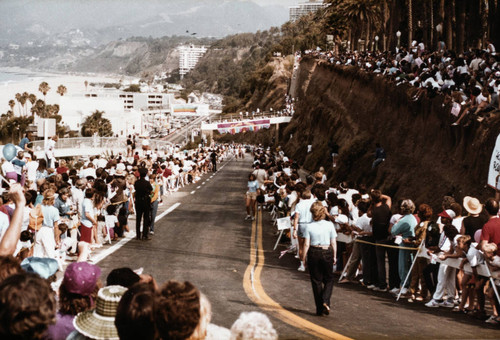 Crowds cheering as Olympic torch bearer O.J. Simpson making his way up ...