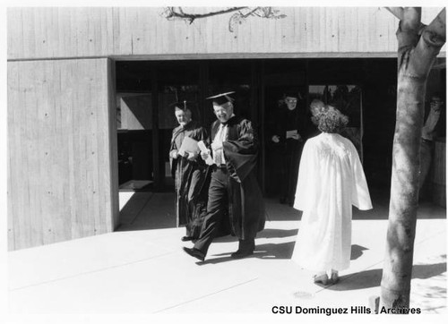 President Gerth exiting building after 1984 Honors Convocation — Calisphere