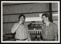 Chris Biaggi samples a glass of Seghesio wine--Ted Seghesio looks on ...