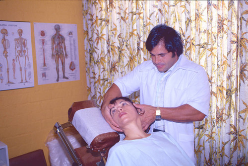 Franco Columbo practicing chiropractic — Calisphere