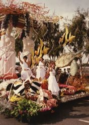 Students riding float during parade — Calisphere