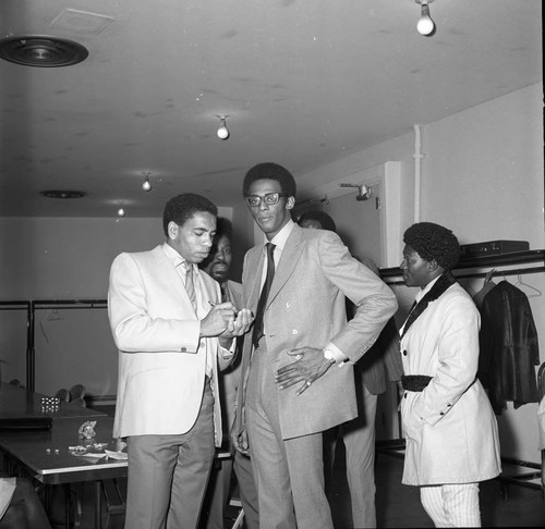 David Ruffin standing with others in a cloak room, Los Angeles, 1969 ...