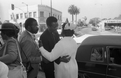Bishop J. A. Blake, Jr. is comforted by an attendee of his father's ...
