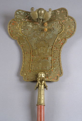 Standard, wood, holding four ornate carved staff. One with prongs, one ...