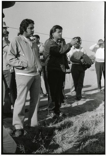 Cesar Chavez speaking (with bodyguards at his side) — Calisphere