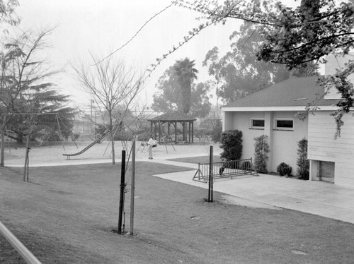 View of the playground and community building at Ladera Park — Calisphere