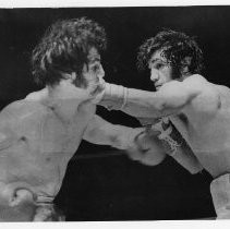 Jean Mateo, left, receives a blow from Carlos Salinas — Calisphere