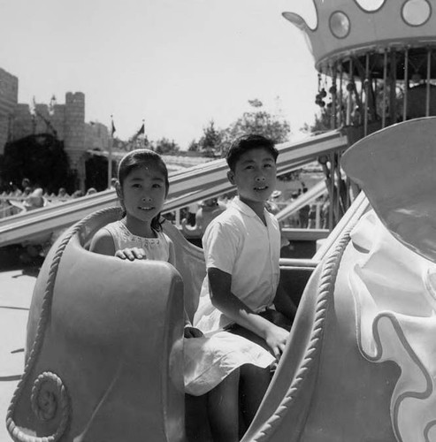 Susan and Henry Quan on the Dumbo ride at Disneyland — Calisphere