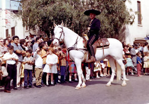 Hernando Courtright on horseback in front of a crowd — Calisphere