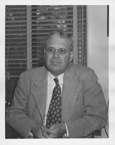 Milton L. Humason, seated at his desk — Calisphere