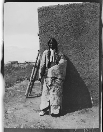John Concha at his ranch, Taos, with old buffalo robe — Calisphere