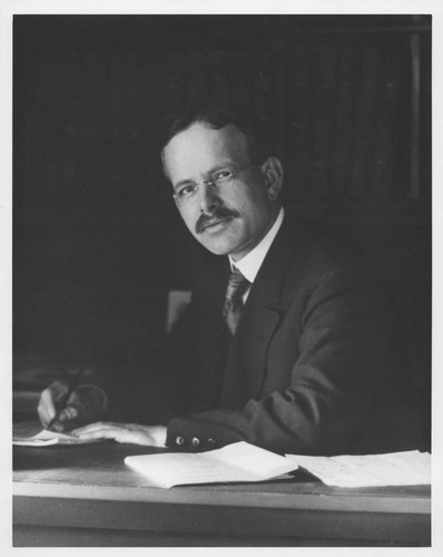 Portrait of George Ellery Hale, seated at his desk, probably at Yerkes ...