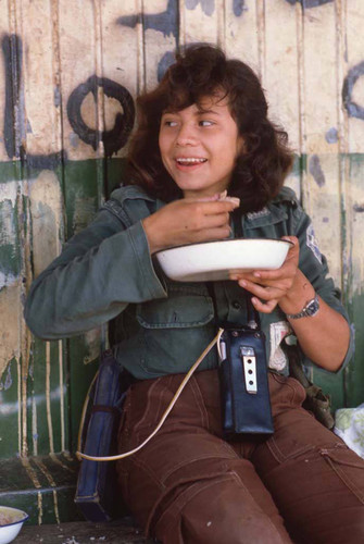 Woman guerrilla eating, San Agustín, 1983 — Calisphere