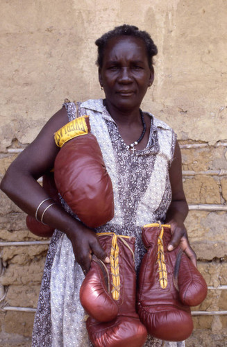 Woman with boxing gloves hanging from her neck, San Basilio de Palenque ...