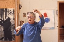 Ann O'Hanlon gesturing in studio while looking sideways, 1977 — Calisphere