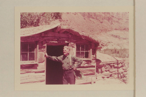 Bert Loper posed by his old cabin in Red Canyon. Photo by a member of ...