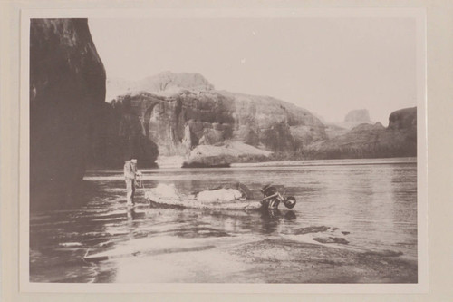 John Wetherill on the icy shore of Glen Canyon holding the painter of ...