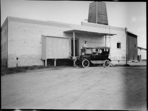 Public ice house with customer purchasing a block of ice at the loading ...
