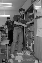 Pepperdine students pick up fallen items in classroom — Calisphere