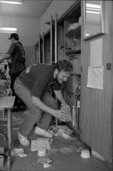 Pepperdine students pick up fallen items in classroom — Calisphere