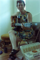 Amy Denio with acoustic guitar and accordion [descriptive] — Calisphere