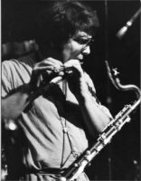 Vinny Golia playing a flute [descriptive] — Calisphere