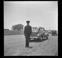 Lynn West poses in front of a car at the entrance of the Air Base where ...