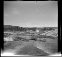 Riverside Geyser erupting into Firehole River, Yellowstone National ...