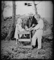 Grace and Walter Biddick help William Mead pluck a chicken, Elliott ...