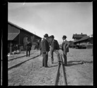 John A. Muir, E. L. Swaine and Clarence Stephens stand on the tracks at ...