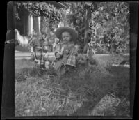 Lucille McIntyre sits with a dog in the front yard of the McIntyre ...