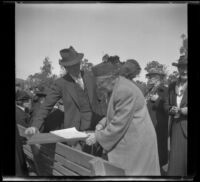 Helen Cook looks at a register at the Iowa Picnic in Lincoln Park, Los ...