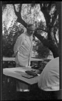 Mayor John C. Porter looks at objects on a table, Glendale, 1932 ...