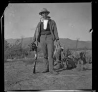 Bob Brain poses with quails and rabbits, Irwindale, about 1900 — Calisphere