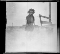 Elizabeth West stands next to a bench on the beach, Venice, about 1905 ...