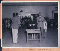 Hazel Washington receiving a certificate from a man in uniform, Los ...