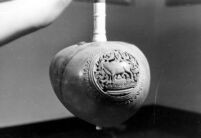 Close-up of an etching of a ram or cow on the base of a bowed fiddle ...