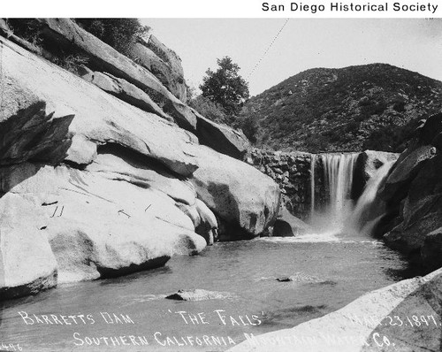 View of a waterfall over a small man-made dam near Barrett Dam — Calisphere