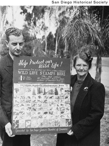 Gerald W. Heilbron and Belle Benchley holding a Wild Life Stamps poster ...