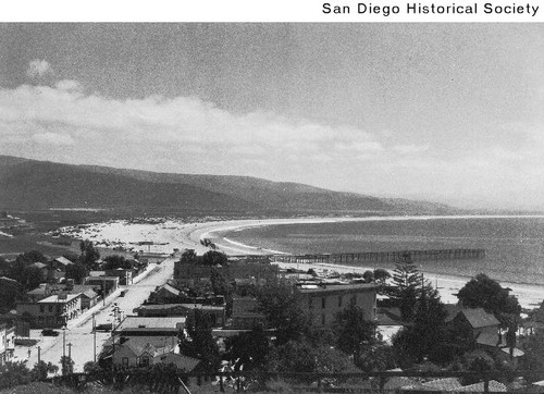View of a the beach and a pier going into the Pacific Ocean at Ensenada ...