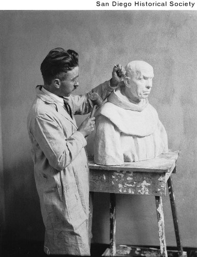 Sculptor Malvin Mar Albright working on a bust of a monk — Calisphere