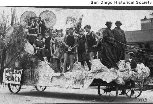 Group of people in bathing suits on a parade float representing Ocean ...
